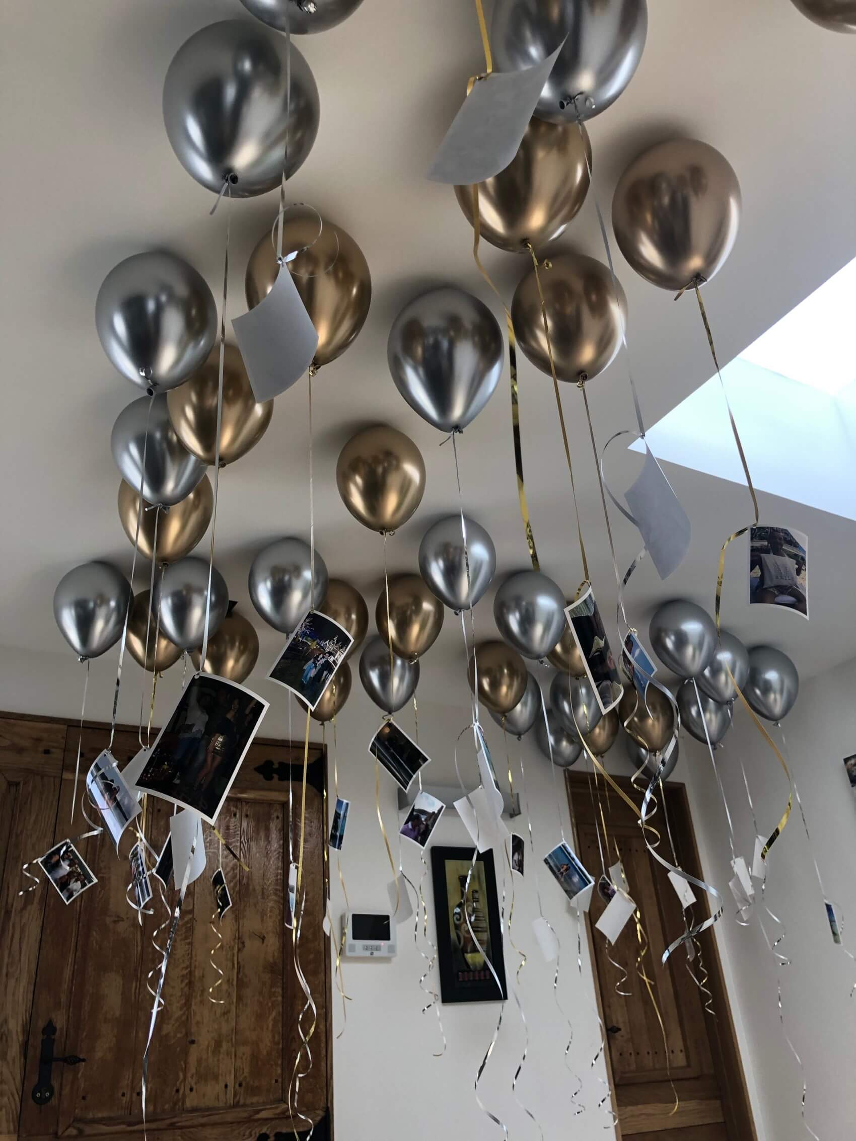 Metallic birthday decoration with gold and silver balloons and ...